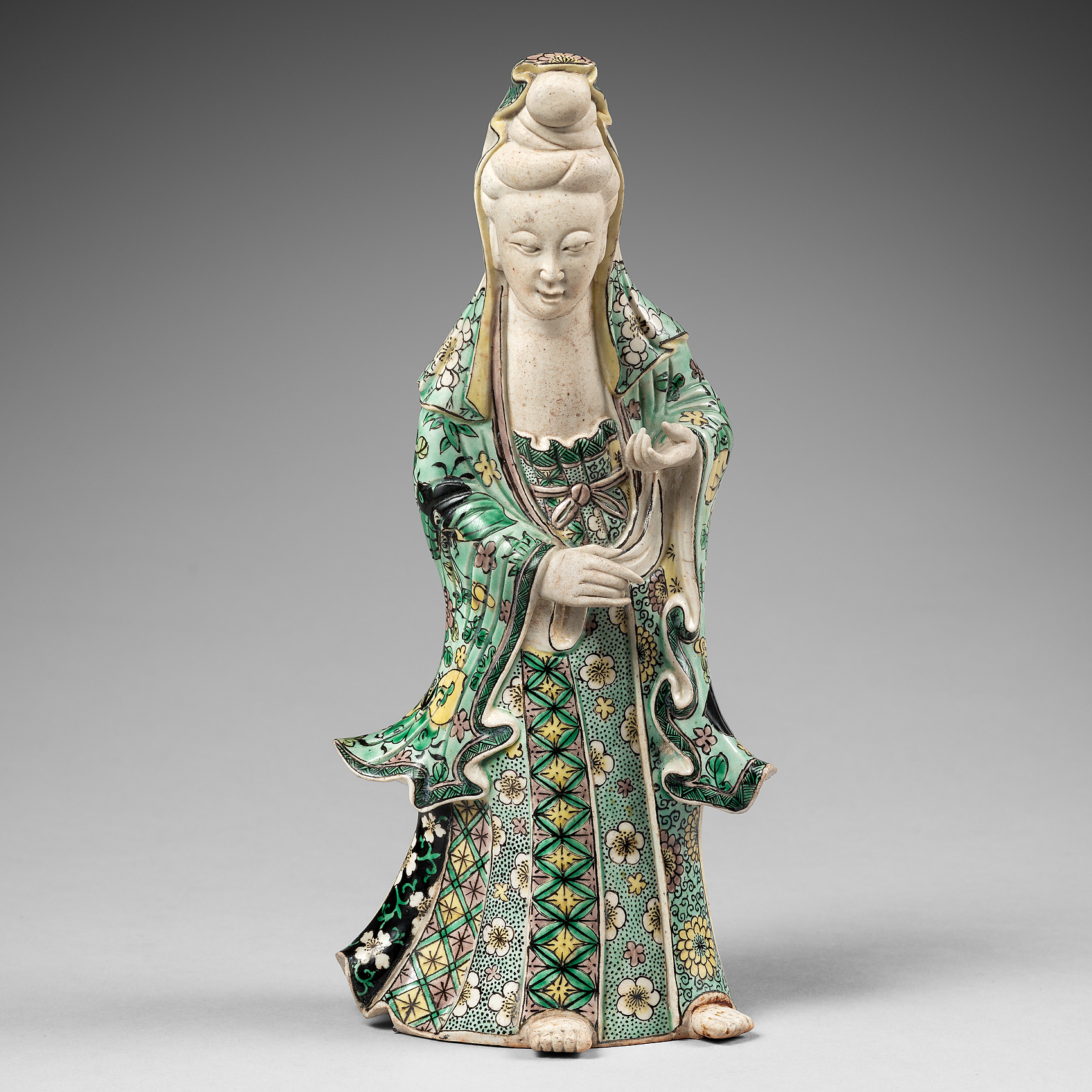 A Chinese famille verte biscuit figure of Guanyin. Kangxi